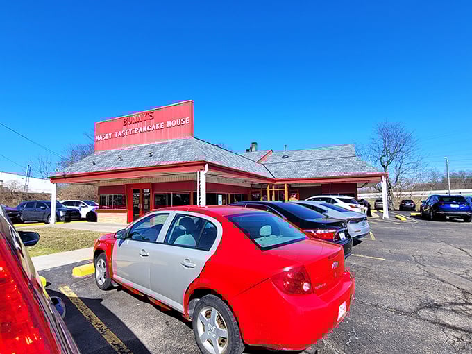The iconic red exterior of Bunny's Hasty Tasty Pancake House glows like a beacon for breakfast lovers. No fancy frills, just the promise of honest-to-goodness comfort food.