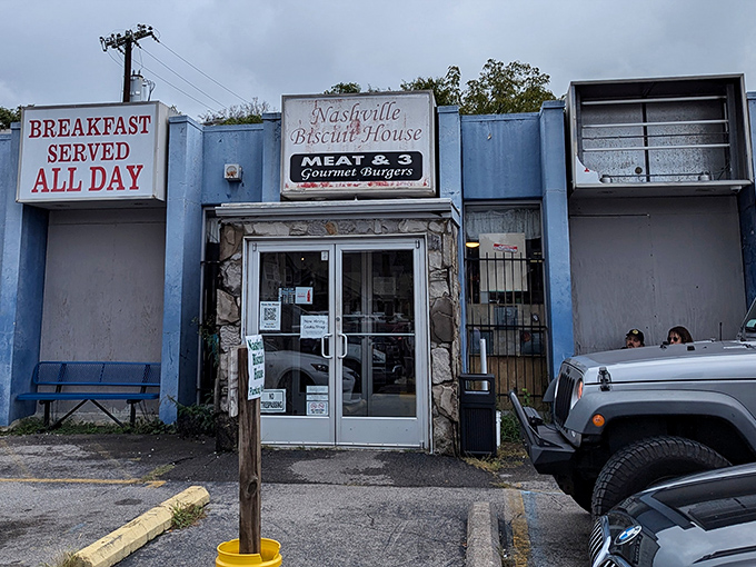 The blue facade and "BREAKFAST SERVED ALL DAY" sign aren't just words—they're a promise that morning's greatest hits are always on tour at Nashville Biscuit House.
