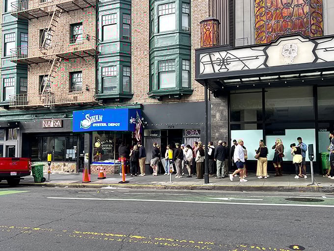 The iconic blue awning of Swan Oyster Depot stands out on Polk Street, where the daily line of seafood pilgrims has become as much a San Francisco landmark as the restaurant itself.