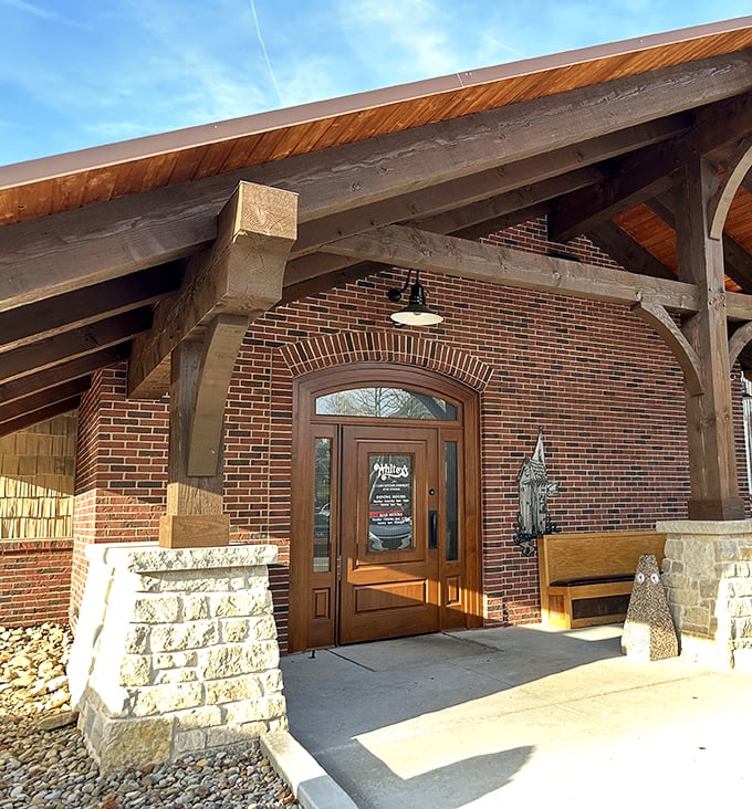 The welcoming entrance to Whitey's features rustic timber beams and warm brick, like a modern lodge that happens to serve incredible burgers.