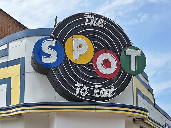 The iconic neon sign of The Spot beckons hungry travelers with its colorful circles – a retro beacon of comfort food promising in downtown Sidney.