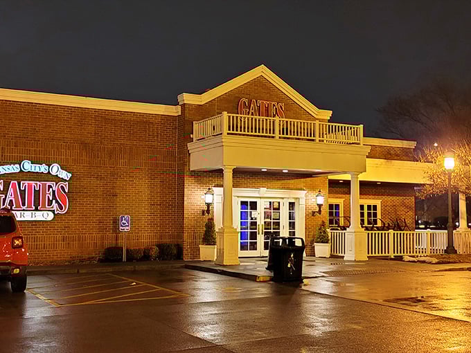 Gates Bar-B-Q glows like a barbecue beacon in the night, its brick façade and white columns promising smoky treasures within.