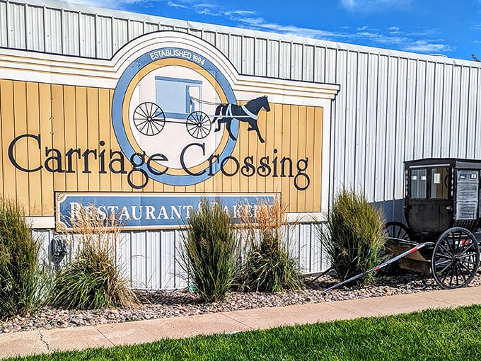 The iconic Carriage Crossing sign welcomes hungry travelers with its Amish-inspired logo—a promise of heartland hospitality waiting just beyond those doors.