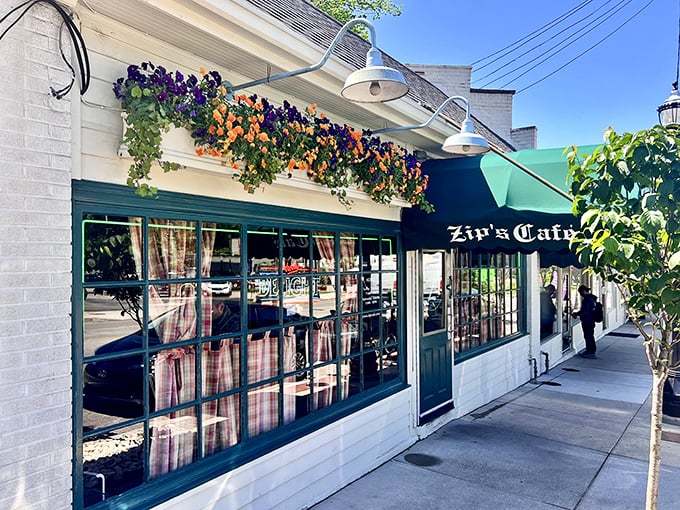 The classic green awning and vibrant flower boxes of Zip's Cafe stand as a colorful beacon in Cincinnati's Mount Lookout neighborhood, promising comfort without pretension.
