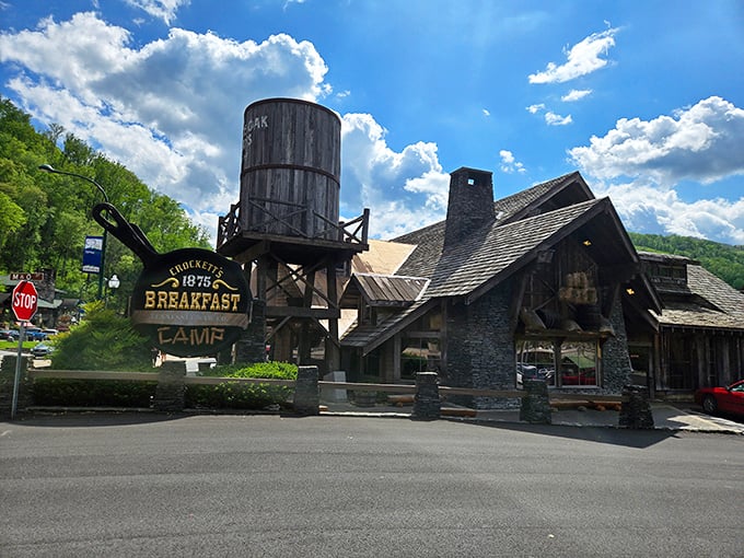 The rustic frontier charm of Crockett's Breakfast Camp stands proudly against Tennessee's blue skies, that water tower announcing "serious breakfast ahead" to hungry travelers.