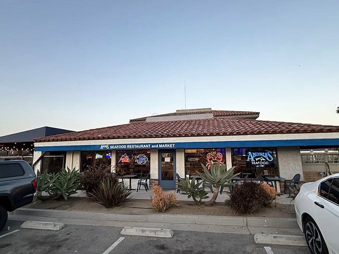 Blue trim and neon signs announce your arrival at seafood paradise. The glowing crab in the window practically waves you inside.