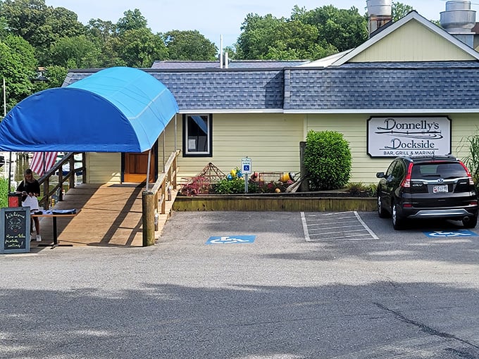 The unassuming yellow exterior of Donnelly's Dockside hides culinary treasures like a pirate's chest disguised as a tackle box.