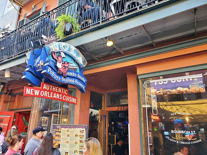 That jaunty crawfish on the sign isn't just waving—he's beckoning you into a French Quarter treasure where seafood dreams come true.