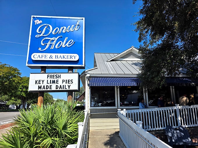 That classic Florida roadside sign against the bright blue sky – like a beacon of hope for hungry travelers seeking salvation in donut form.