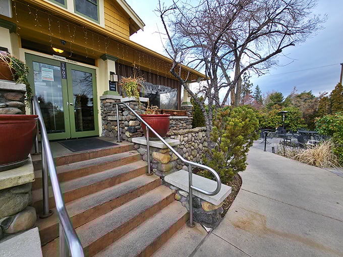The Stone House Café's charming exterior welcomes you with rustic stone steps and green doors, like a secret garden hideaway in the middle of Reno.