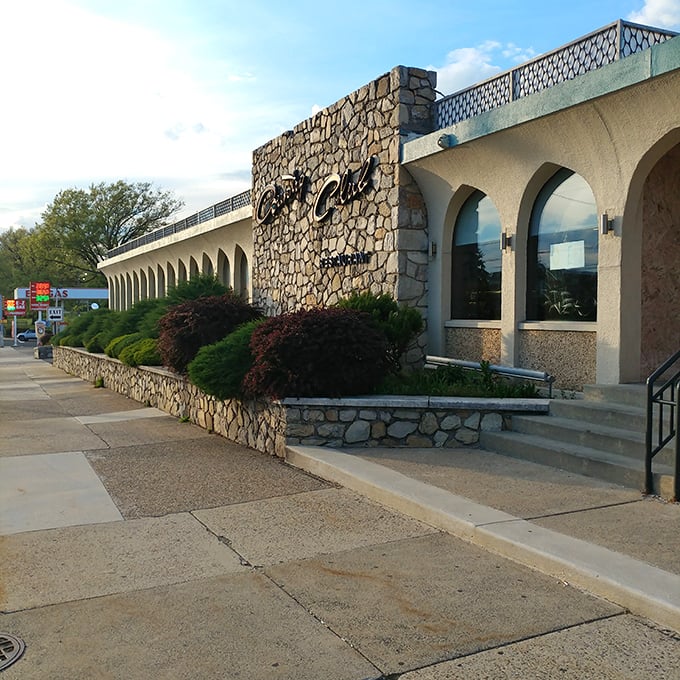 The stone facade of Country Club Diner stands like a mid-century modern time capsule, promising comfort food treasures within its arched entryway.