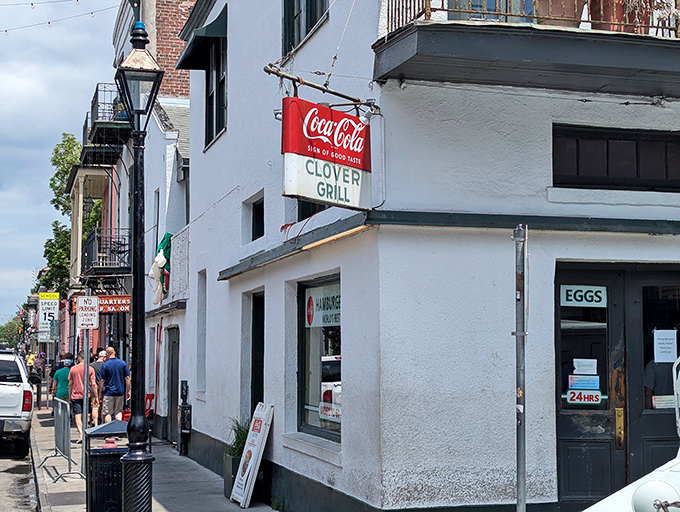The corner of Bourbon and Dumaine reveals this unassuming treasure – where the vintage Coca-Cola sign and "EGGS" window promise breakfast salvation 24 hours a day.