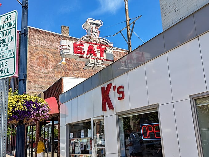 That vintage "EAT" sign towering over Main Street isn't suggesting—it's demanding, and you should absolutely obey.