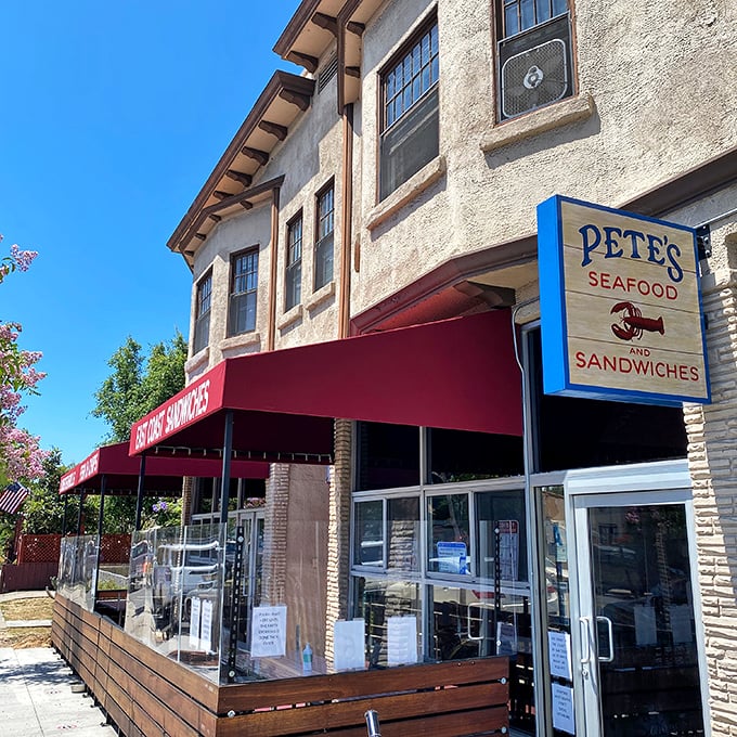 The unassuming storefront with its red awning and wooden patio railing is like a secret handshake among San Diego seafood lovers—modest exterior, extraordinary flavors within.