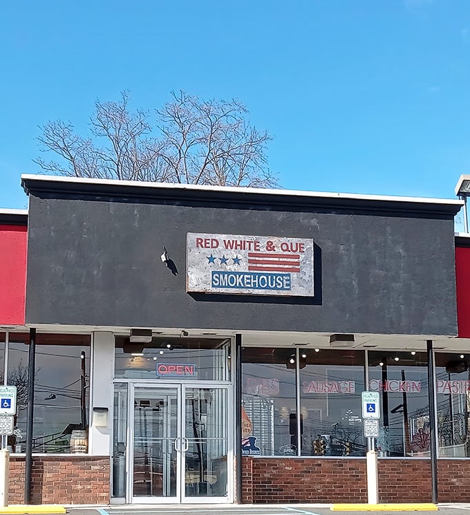 The weathered sign against that dark facade isn't just decoration—it's a promise of smoky delights waiting inside. No frills, just thrills for your taste buds.