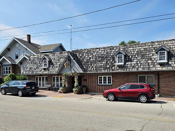 The inviting brick exterior of Schwarz’s, framed by a cheerful floral archway, seems to whisper, “Abandon your diet—all are welcome here.”