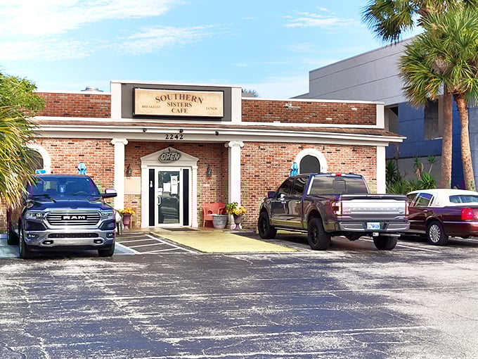 The unassuming brick exterior and cheerful yellow walkway prove that in Florida, the best breakfasts often hide in plain sight at Southern Sisters Café.