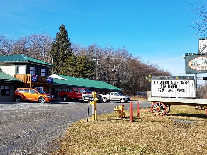 The Summit Lodge & Grill welcomes hungry travelers with its rustic charm and roadside sign promising elk burgers, fish dinners, pizza, and wings—Pennsylvania comfort at its