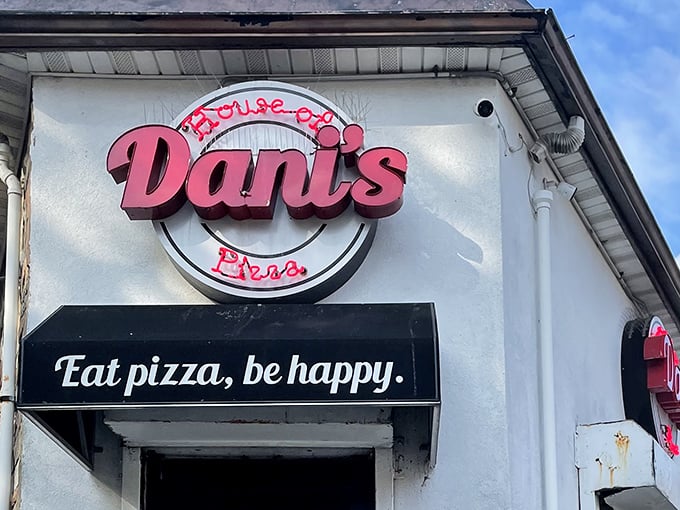 The neon sign says it all: "Eat pizza, be happy." Has there ever been a more perfect life philosophy etched in pink and white?
