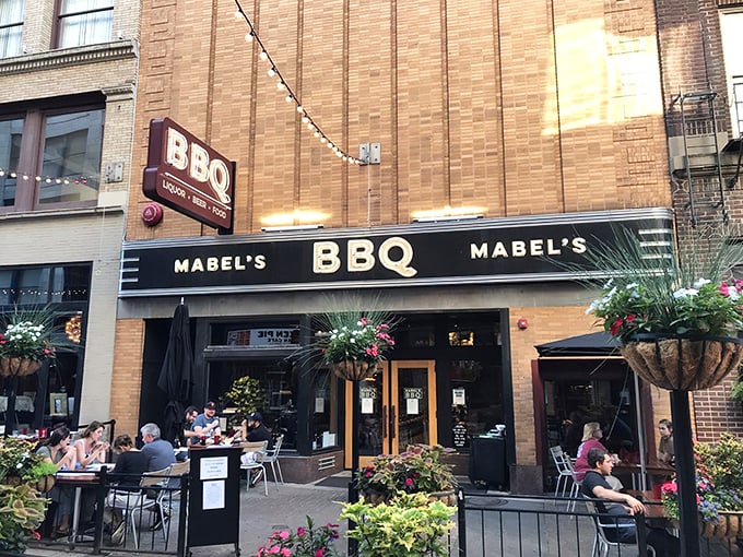 The inviting storefront of Mabel's BBQ on East 4th Street beckons with its classic brick facade and outdoor seating—a Cleveland meat lover's paradise in disguise.