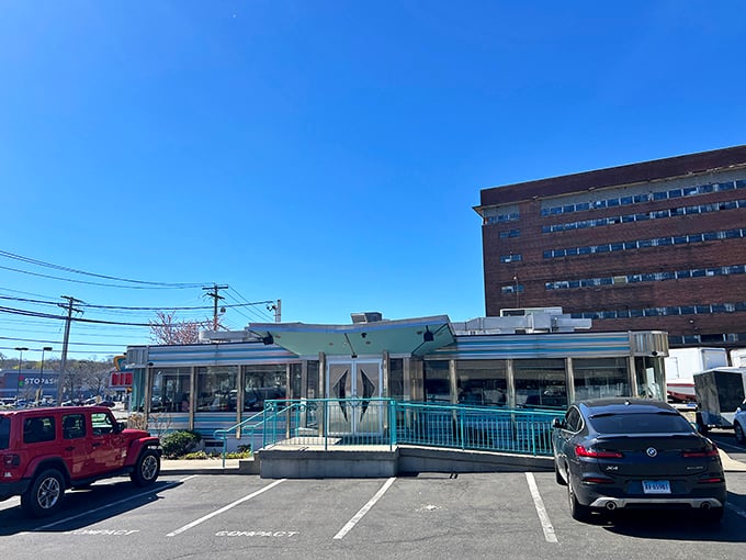 The classic American diner dream stands proudly against Connecticut's blue sky, promising comfort food treasures within its gleaming, retro exterior.