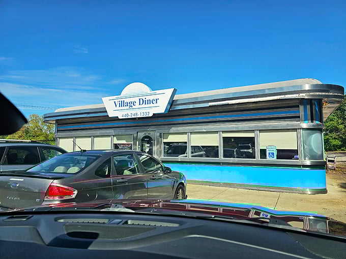 The classic chrome-and-blue exterior of Village Diner gleams like a time machine to the golden age of American breakfast. Pure roadside magic!