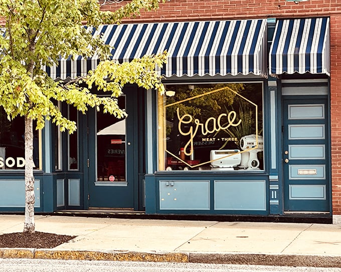 Grace Meat + Three's classic brick exterior with blue and white awnings stands as an unassuming gateway to Southern comfort food paradise in St. Louis's vibrant Grove neighborhood.