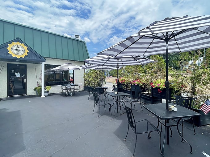 The welcoming exterior of Shorty's Sunflower Cafe, where those striped umbrellas promise shade for your breakfast adventures and vibrant conversations.