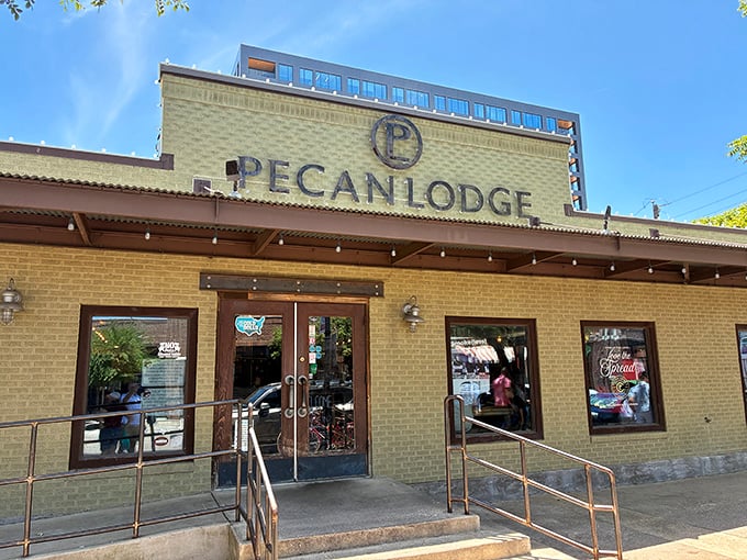 The yellow brick exterior of Pecan Lodge stands like a temple to Texas BBQ, beckoning hungry pilgrims to its smoky sanctuary in Deep Ellum.