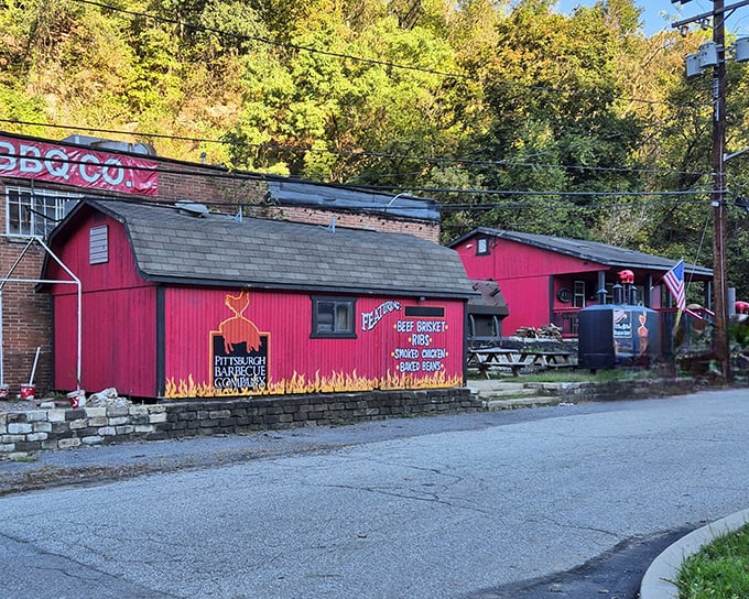The bright red barn-like structure isn't subtle about its mission—flames painted along the bottom announce that serious barbecue happens here in Banksville.