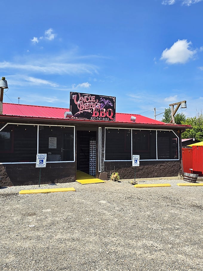 The humble red-roofed exterior of Uncle Beth's BBQ stands like a beacon for smoke-seekers, promising authentic flavors behind its unassuming façade.