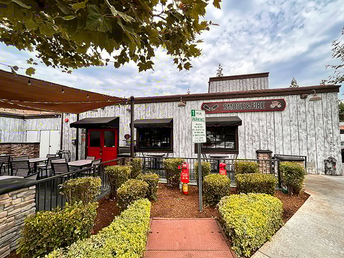 That weathered white exterior isn't fooling anyone—this barbecue joint houses smoky treasures that would make a Texan tip their hat in respect.