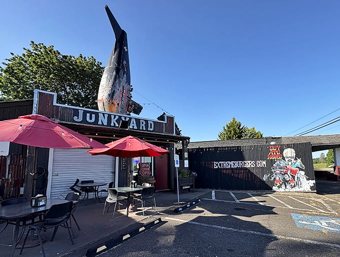 The airplane fin jutting from the roof isn't subtle advertising—it's a declaration that your taste buds are about to take flight at this corrugated metal wonderland. 