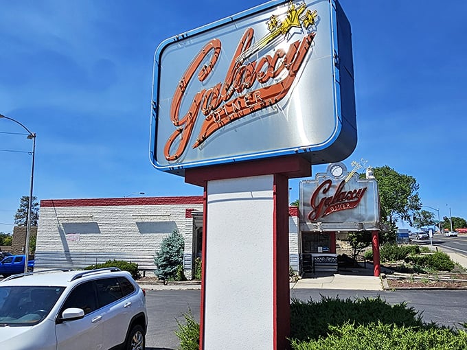 That neon sign isn't just announcing a restaurant—it's broadcasting a promise of time travel to an era when calories didn't count and chrome was king.