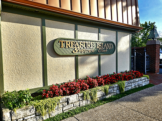 The welcoming facade of Treasure Island Supper Club, where vibrant flowers greet you before the steaks do. A hidden gem in plain sight.