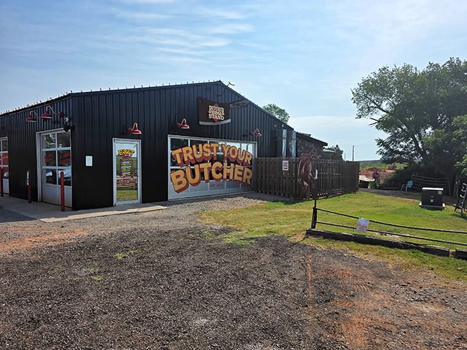 The bright red exterior of The Butcher BBQ Stand isn't just eye-catching—it's a smoke signal to barbecue pilgrims that they've reached the promised land.