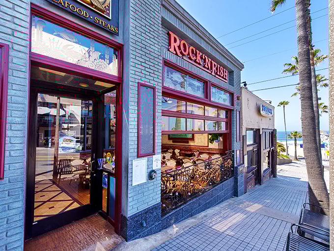 The iconic blue exterior of Rock'N Fish stands out like a beacon of culinary promise, with the ocean breeze practically inviting you inside for seafood adventures.