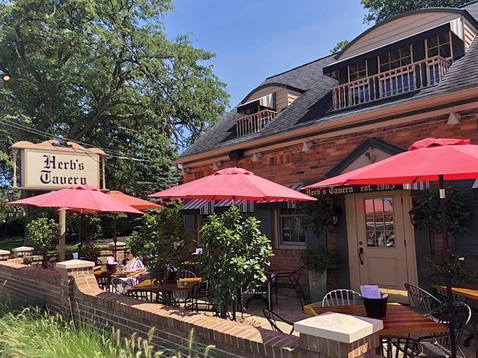 The brick facade and cheerful red umbrellas of Herb's Tavern beckon like an old friend saying, "Come on in, the comfort food's waiting."