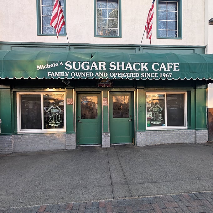 American flags proudly flank the entrance, announcing this isn't just a cafe—it's a local institution where beach town traditions are served daily alongside the coffee.