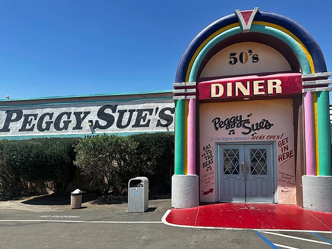 The jukebox-shaped entrance to Peggy Sue's stands like a technicolor mirage in the desert, promising relief for weary travelers and hungry road-trippers alike.