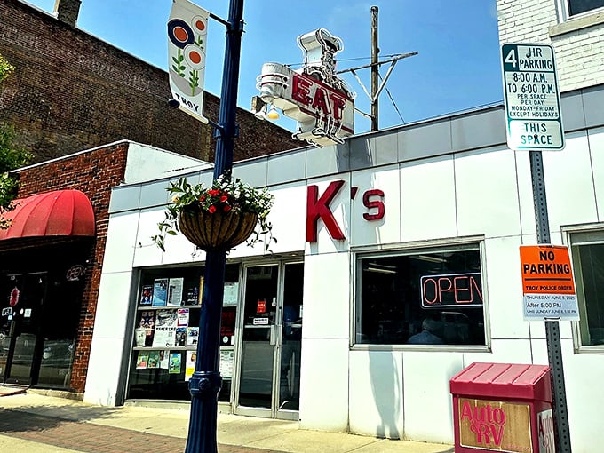 That vintage "EAT" sign towering over Main Street isn't suggesting—it's demanding, and you should absolutely obey.