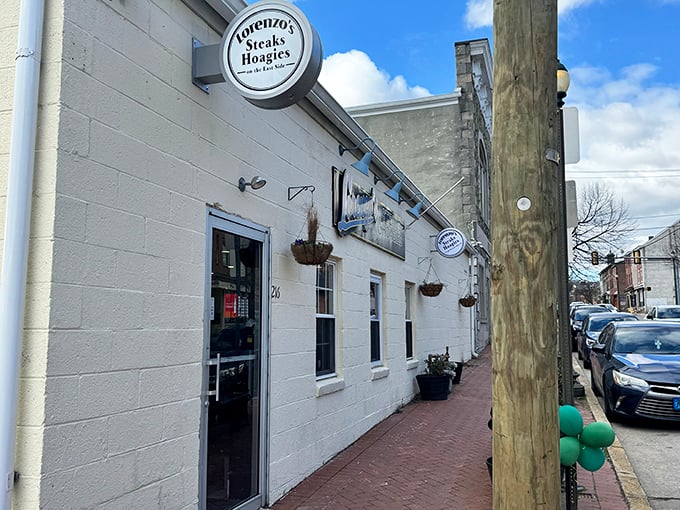 A simple circular sign marks the spot where cheesesteak dreams come true. The brick pathway practically begs you to follow it to sandwich nirvana.