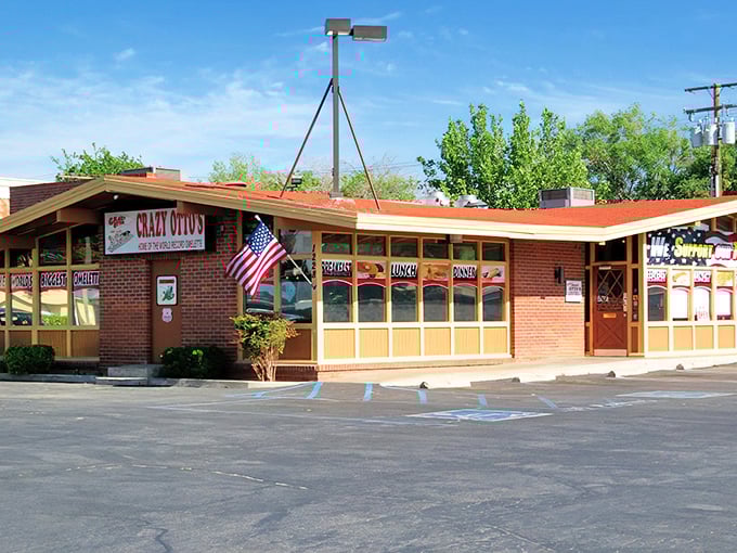 The classic brick exterior of Crazy Otto's Diner stands like a beacon of hope for hungry travelers. That American flag isn't just decoration—it's a promise of authentic diner goodness.