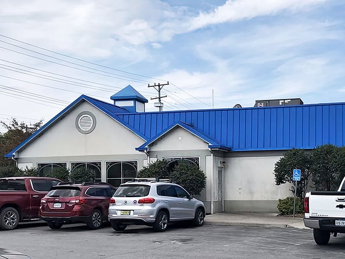 The distinctive blue-roofed building stands ready to welcome burger pilgrims. Like a culinary lighthouse guiding you to flavor harbor.