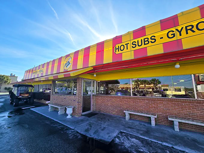That striped awning isn't just eye-catching—it's a North Myrtle Beach landmark promising hot subs, gyros, and pizza that'll make your taste buds throw a standing ovation.