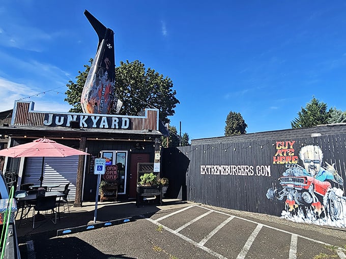 Blue skies frame the ultimate roadside attraction—where "junkyard" isn't an insult but a promise of automotive-themed deliciousness.