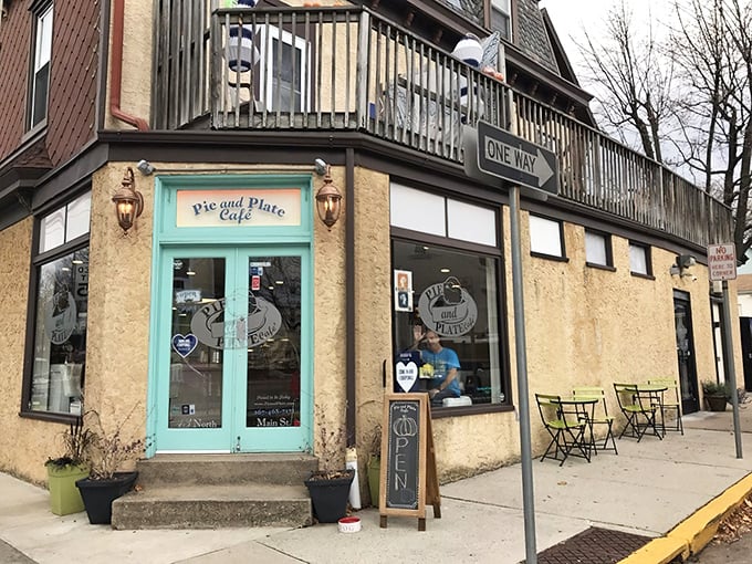 That turquoise door isn't just an entrance—it's a portal to flaky, buttery happiness disguised as a corner cafe.