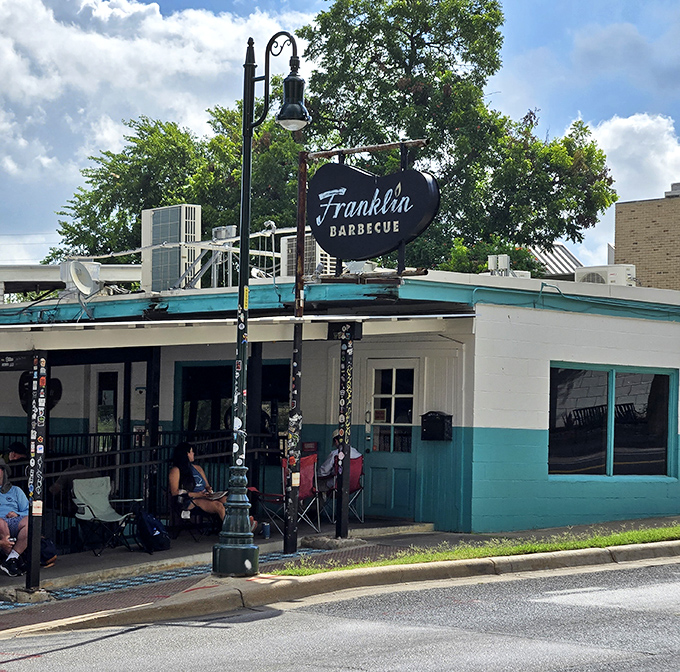 The turquoise exterior of Franklin Barbecue stands like a humble temple to smoked meat, complete with the most sacred sight in Austin: waiting chairs.
