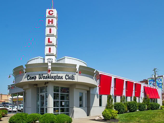 The iconic Camp Washington Chili building stands like a retro beacon of hope for the hungry, its vertical "CHILI" sign a siren call to comfort food seekers.