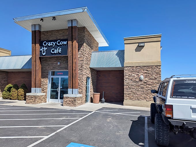 The stone facade of Crazy Cow Café stands proudly against Utah's blue sky, like a beacon for hungry travelers seeking refuge from fast-food mediocrity.